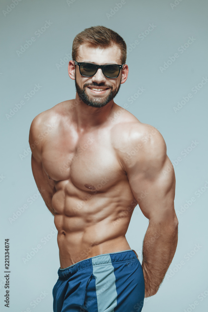 .bodybuilder posing. Beautiful sporty guy male power. Fitness muscled ...
