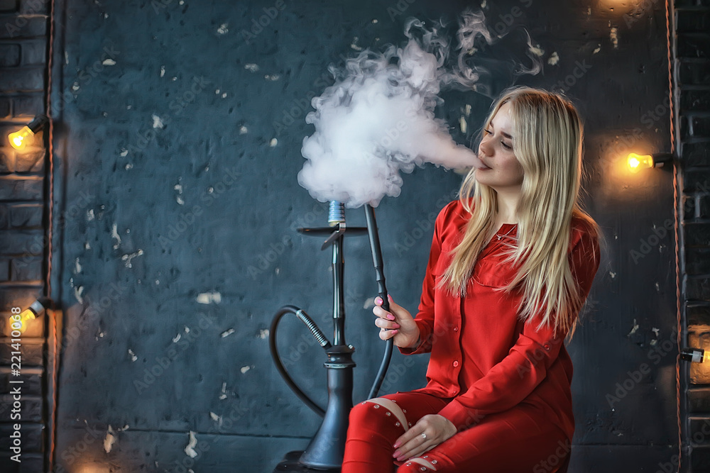 girl smokes hookah / beautiful glamorous girl in red dress smokes a ...