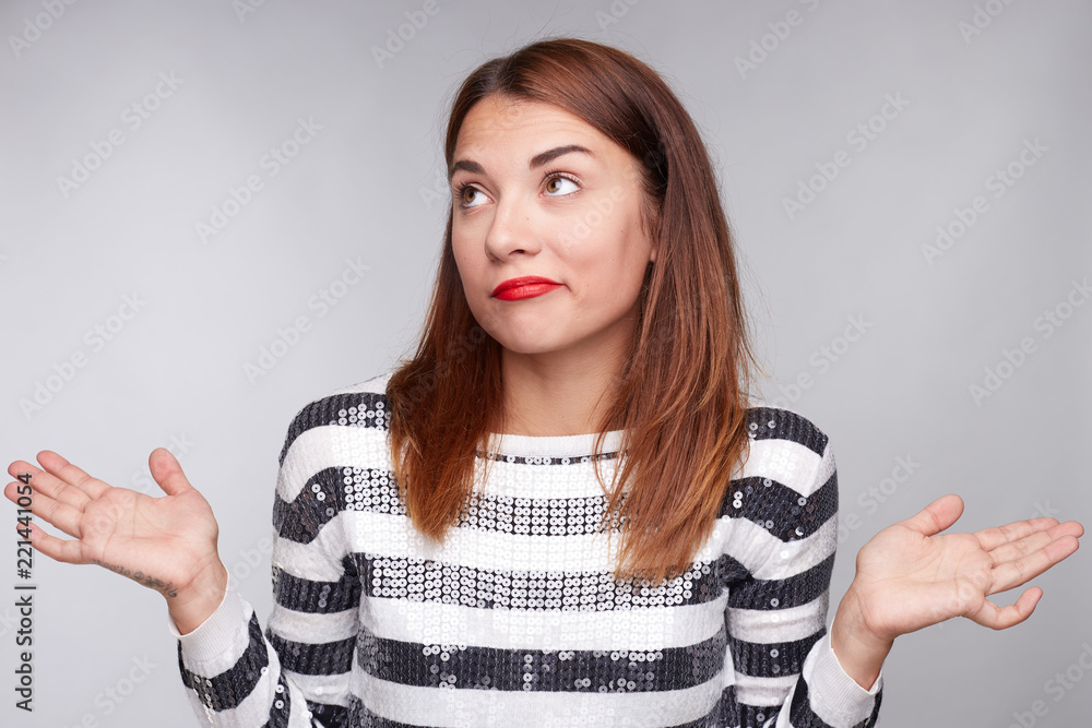 Puzzled hesitant attractive female with clueless expression, curves red ...