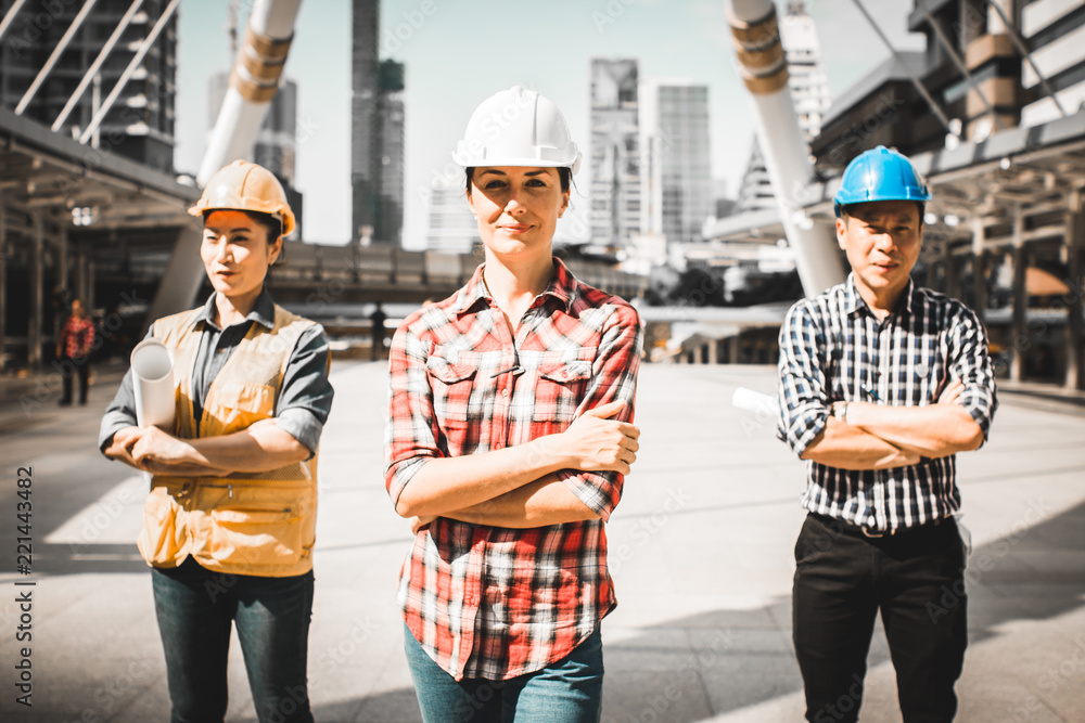 Three Industrial engineer wear safety helmet engineering standing with ...