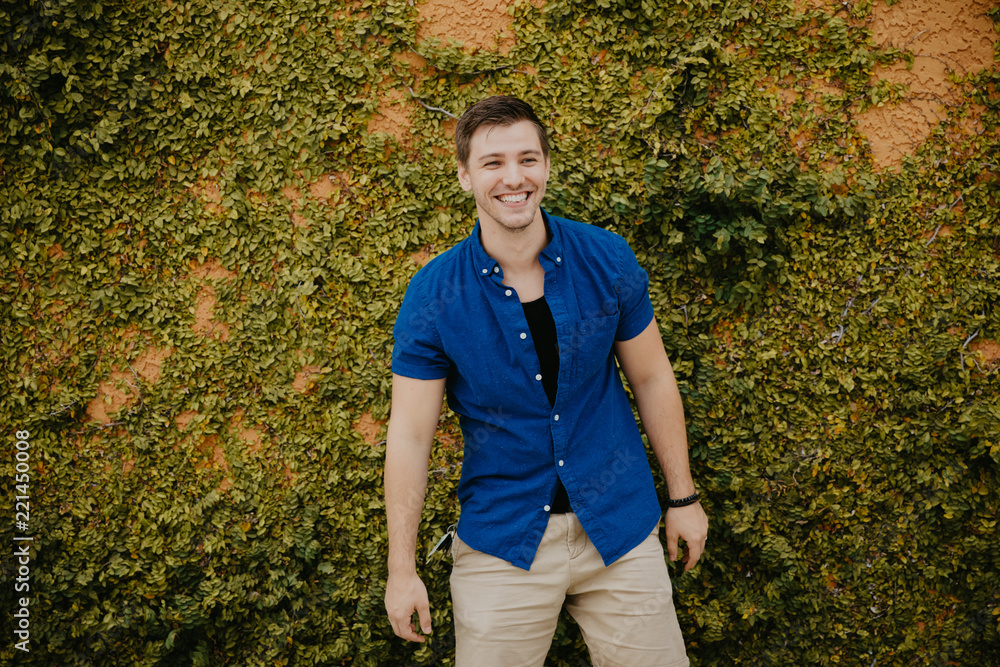 Attractive Male Model in Blue Collared Shirt in front of Orange ...