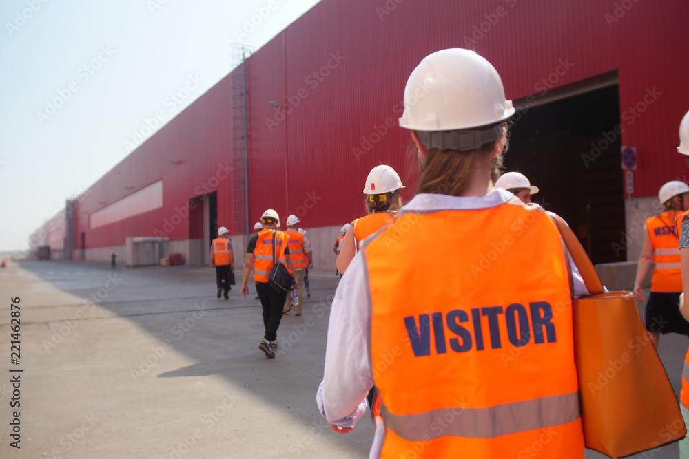 factory inspection. group of visitors on the factory tour. people go in ...