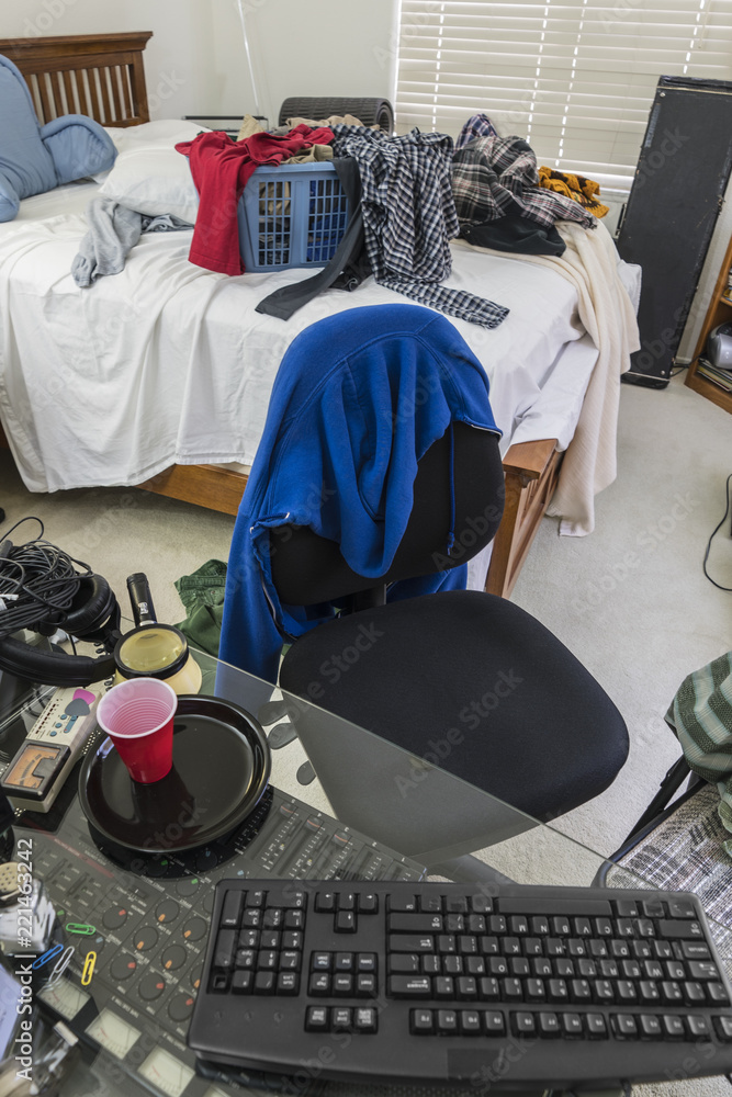 Messy, cluttered teenage boys bedroom with piles of clothes. Vertical ...
