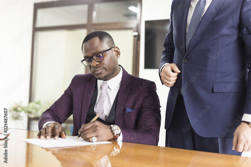 Fotografia do Stock: African american man signing contract, black man ...