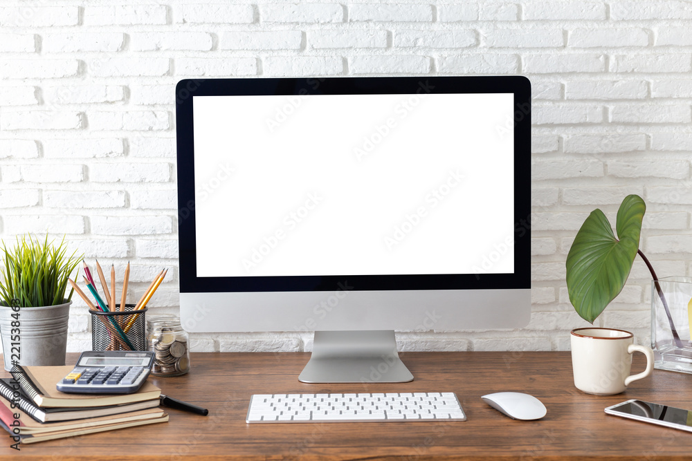 workspace with computer with blank white screen, and office supplies on ...