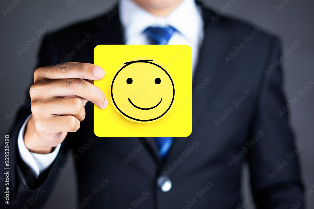 Businessman hold a happy face icon drawn on paper, Customer experience ...