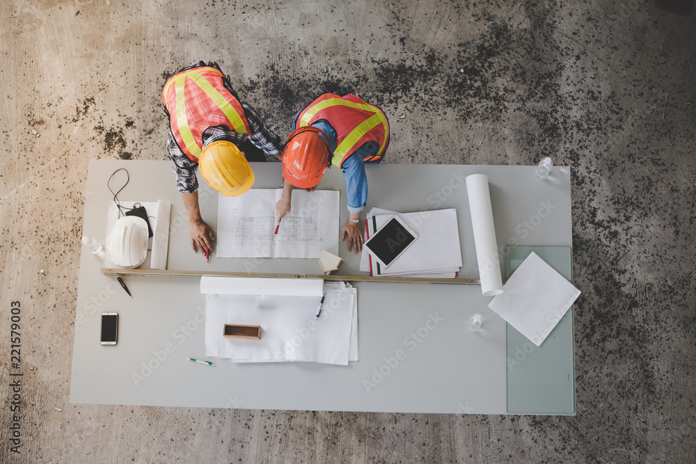 Top view of architects and engineers to help create a blueprint to ...