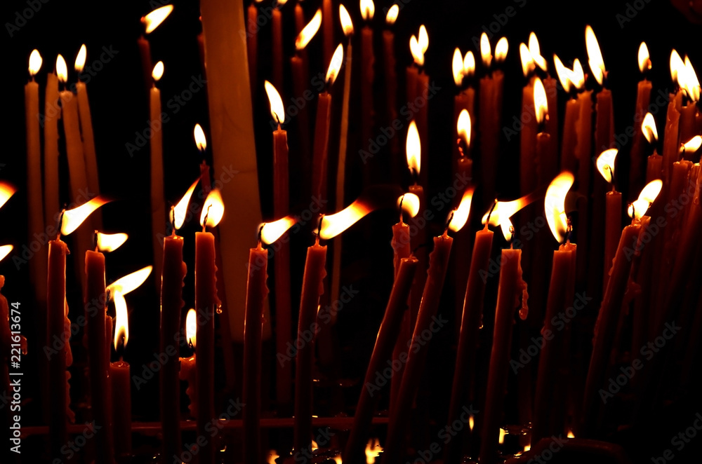 Many church candles burn in the dark. Candles in the Church of the Holy ...