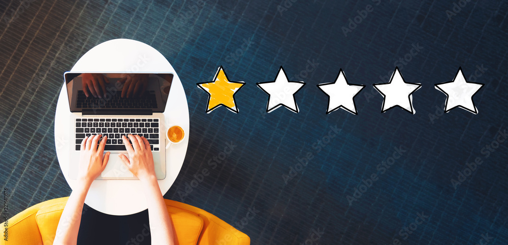 One Star Rating with person using a laptop on a white table Stock Photo ...