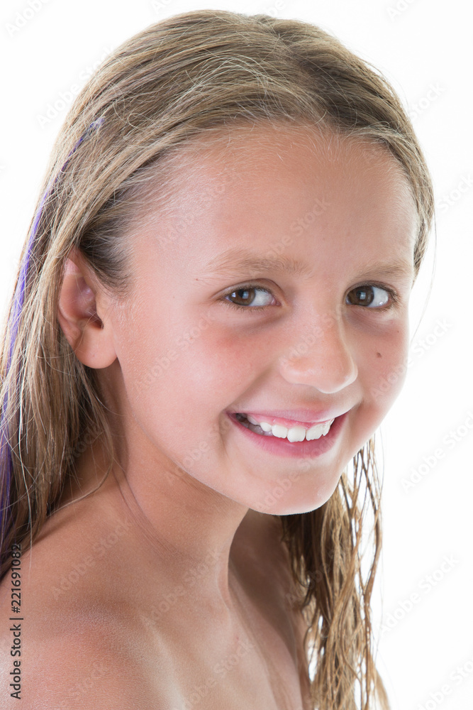 Studio shot of young little 9-10 year old girl smiling in white ...