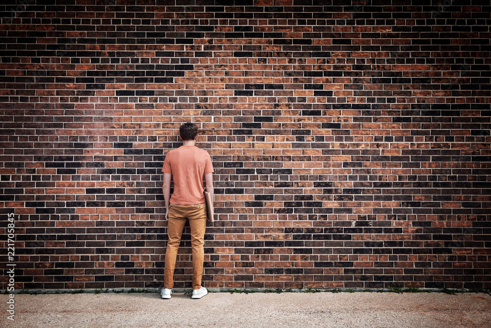 Student blending into brick wall Stock Photo | Adobe Stock