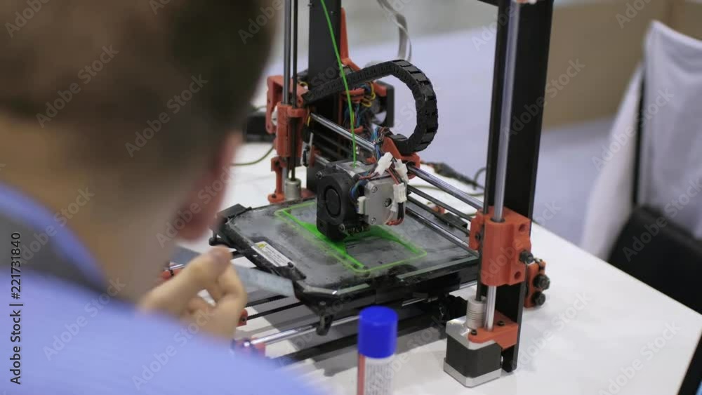 Engineer male looking at 3d printer at work. 3D printing manufacture ...