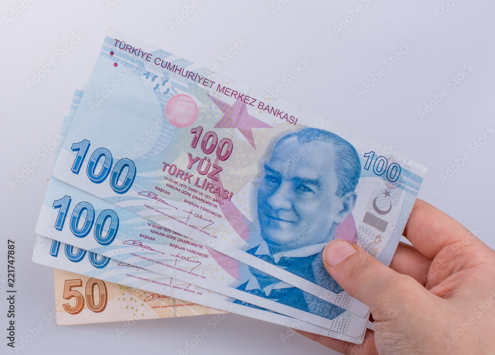 Hands holding American dollar banknotes and Turksh Lira banknotes side ...