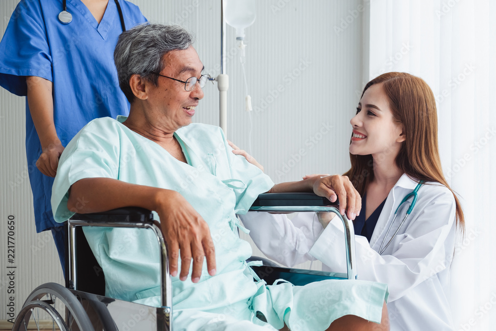 Stockfoto Asian doctor woman and nurse encourage disabled old man ...
