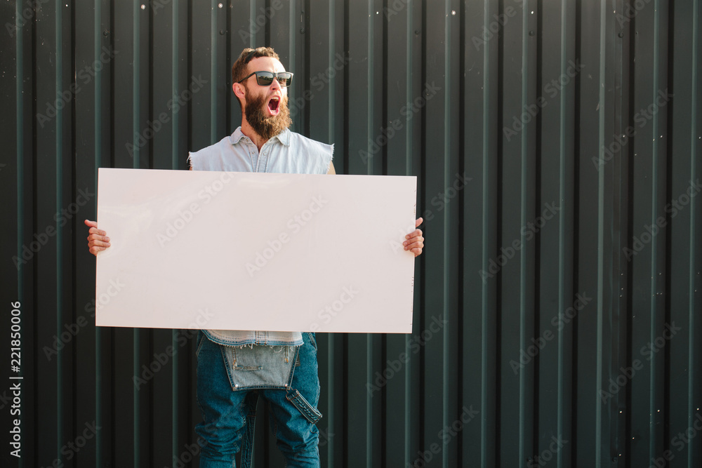 Hipster man holding a poster Stock Photo | Adobe Stock