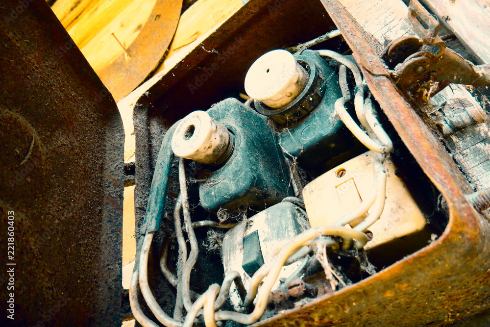 Old electric power supply boxes. Industrial background. Overloaded ...