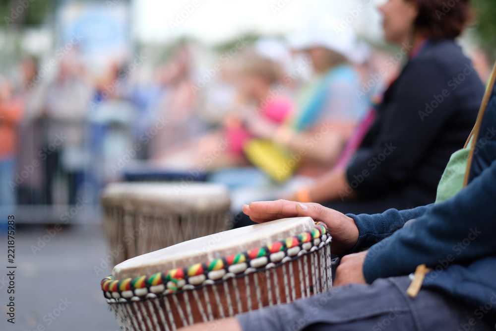 Hands of a musician playing on an African djembe drum, at a percussion ...