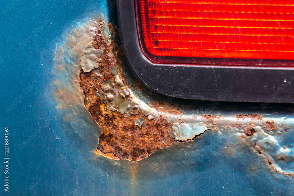 Rust hole on worn car body painting close up details as background ...