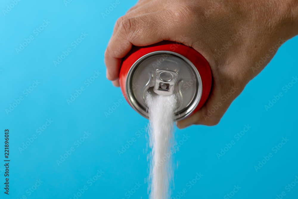 Hand holding soda can pouring lots of sugar in metaphor of sugar ...