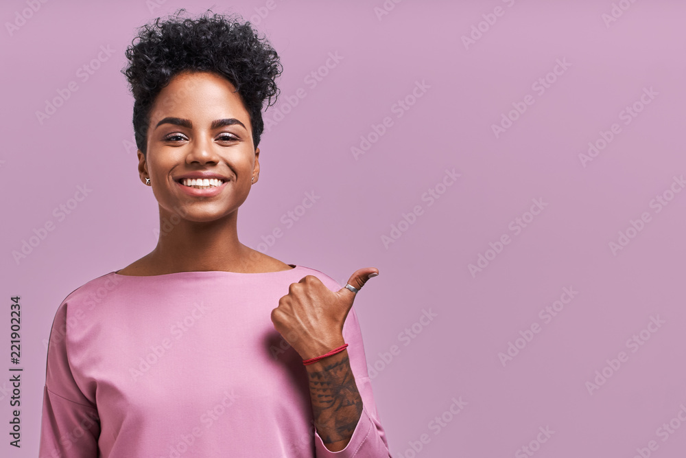 Horizontal shot of beautiful female with dark skin keeps mouth opened ...