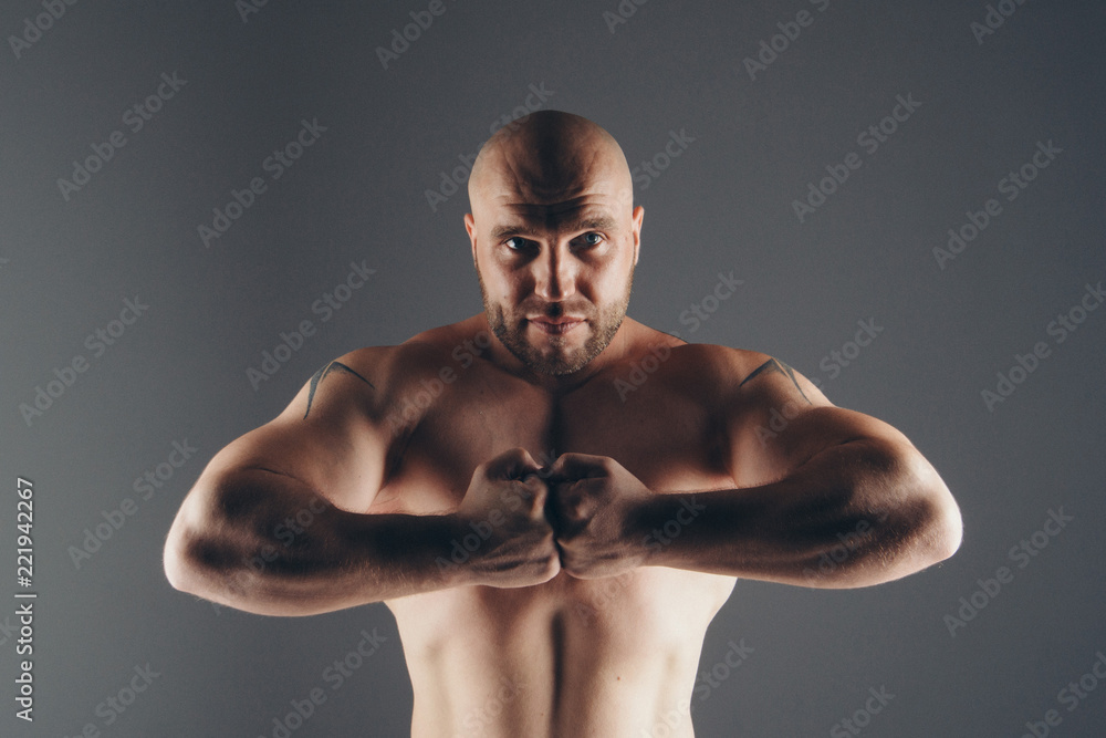 Close-up of the bodybuilder's face: a muscular man with his mouth open ...