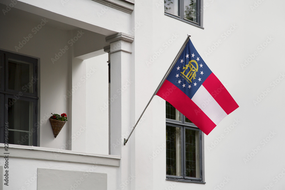 Georgia flag. Georgia state flag hanging on a pole in front of the ...