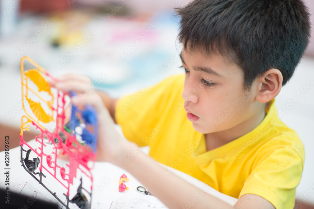 Little boy build model kits toy depicting the vehicles and characters ...