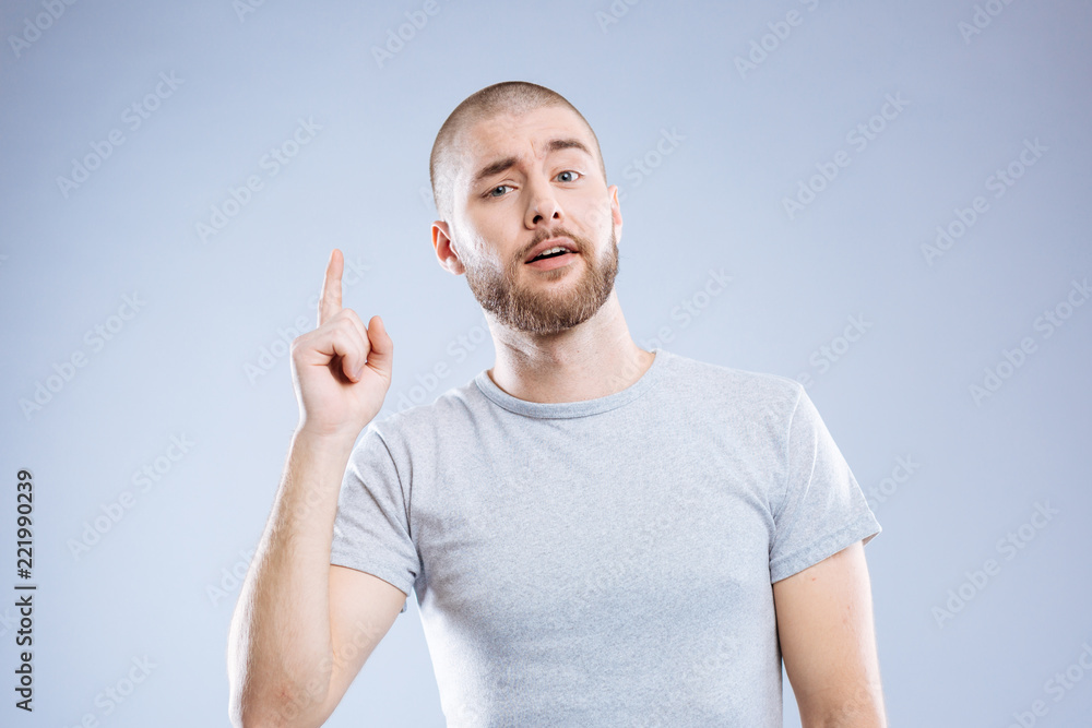 Perfect solution. Smart intelligent man pointing up with his finger ...