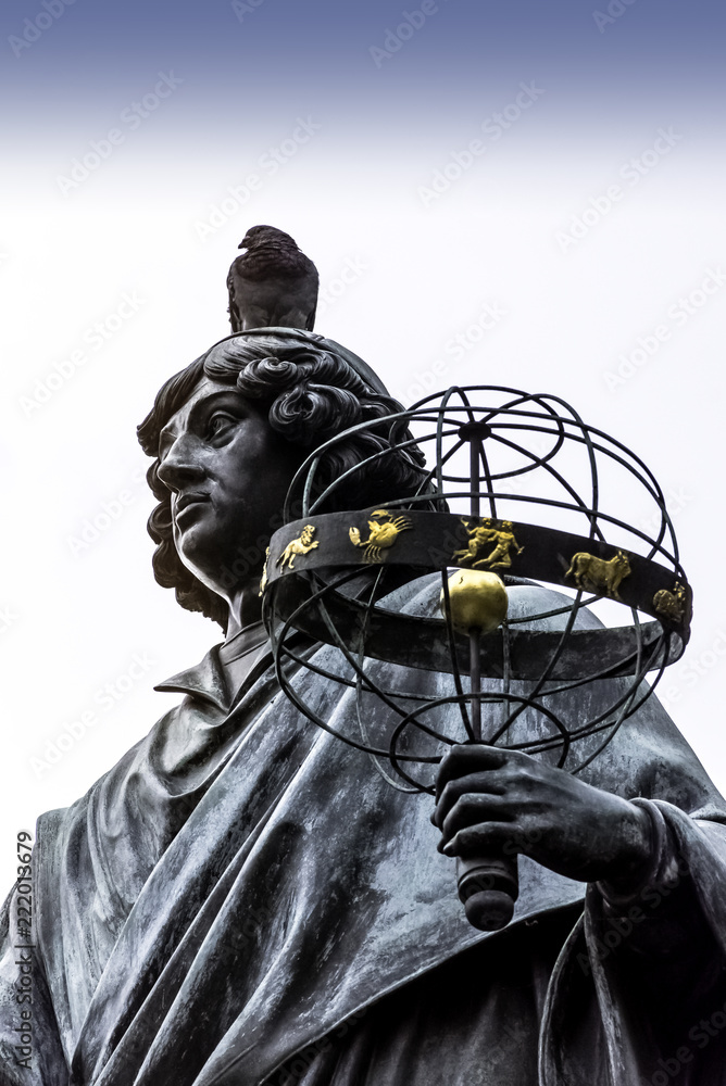 Pigeon sitting on Copernicus head - Nicolaus Copernicus Monument in the ...