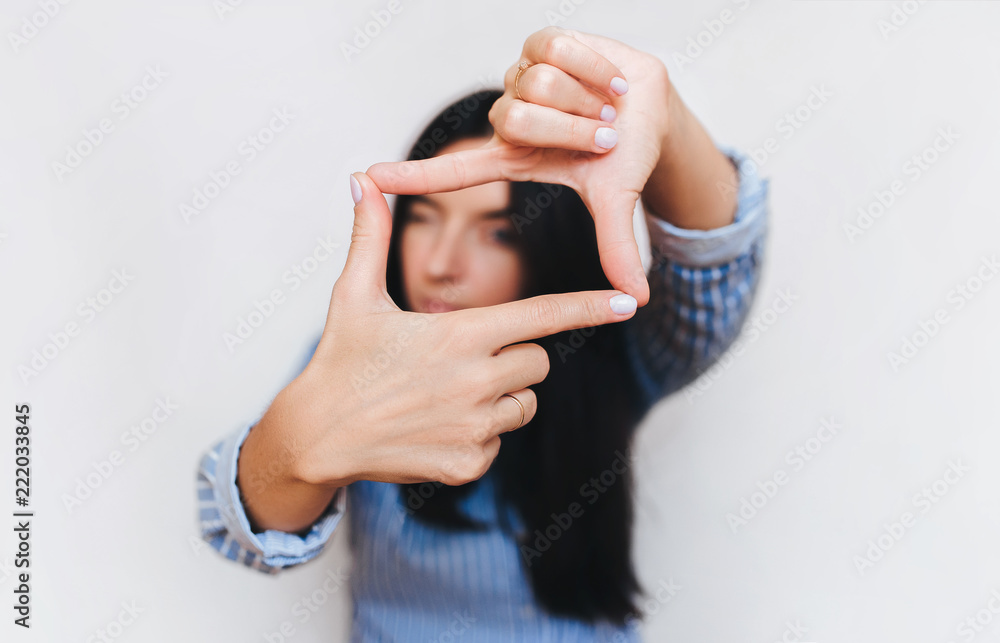 Female hands are planning a focus in the frame. Focal crop composition ...