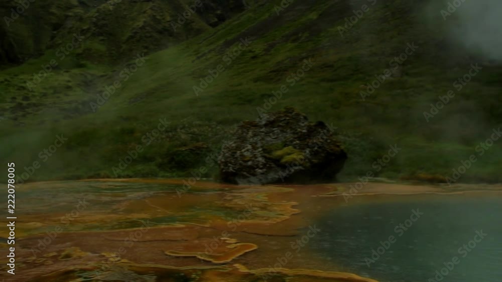 iceland landscape, geothermal hot spring pool steam smoke rising, rainy ...