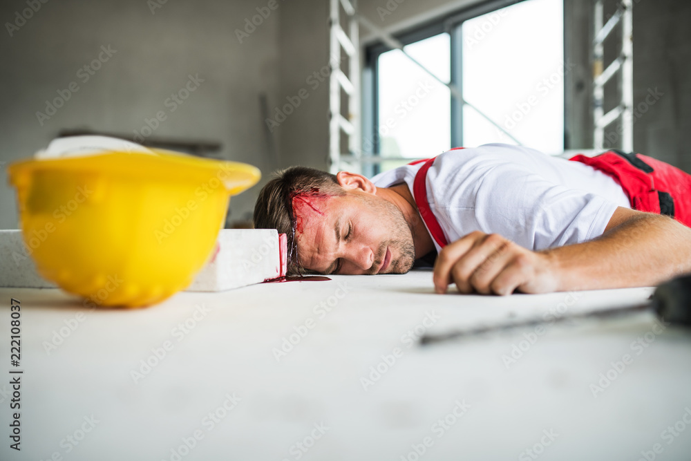 An unconscious man worker lying on the floor after accident on the ...