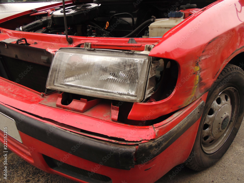 broken front side wing of a red car after an accident Stock Photo ...