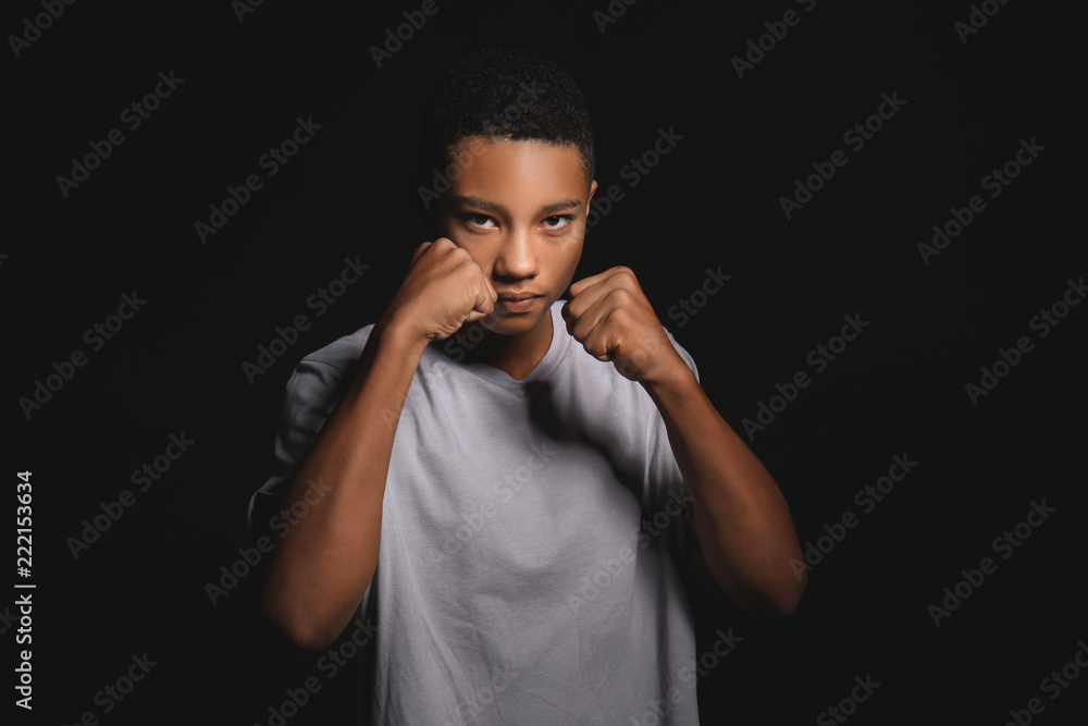 Bully African-American teenage boy on dark background Stock Photo ...