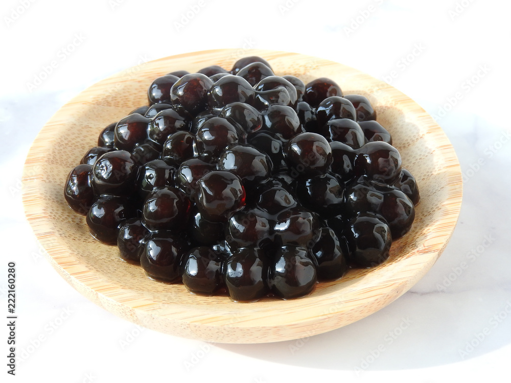 High angle view of tapioca ball (also known as boba in bubble tea) on wooden plate isolated on ...