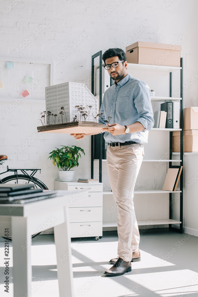 handsome architect holding architecture model in office Stock Photo ...