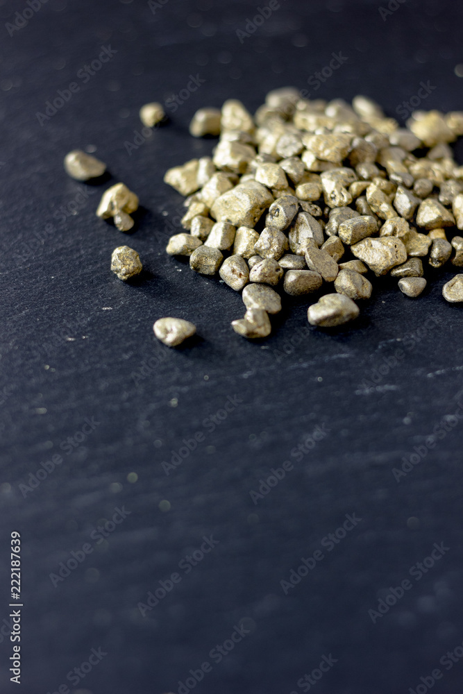 Sand of gold at black stone board Stock Photo | Adobe Stock