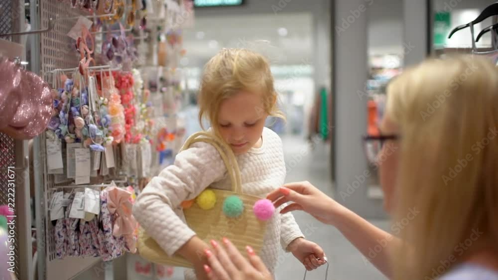 Happy family doing shopping. Family in mall. Mother helping her ...