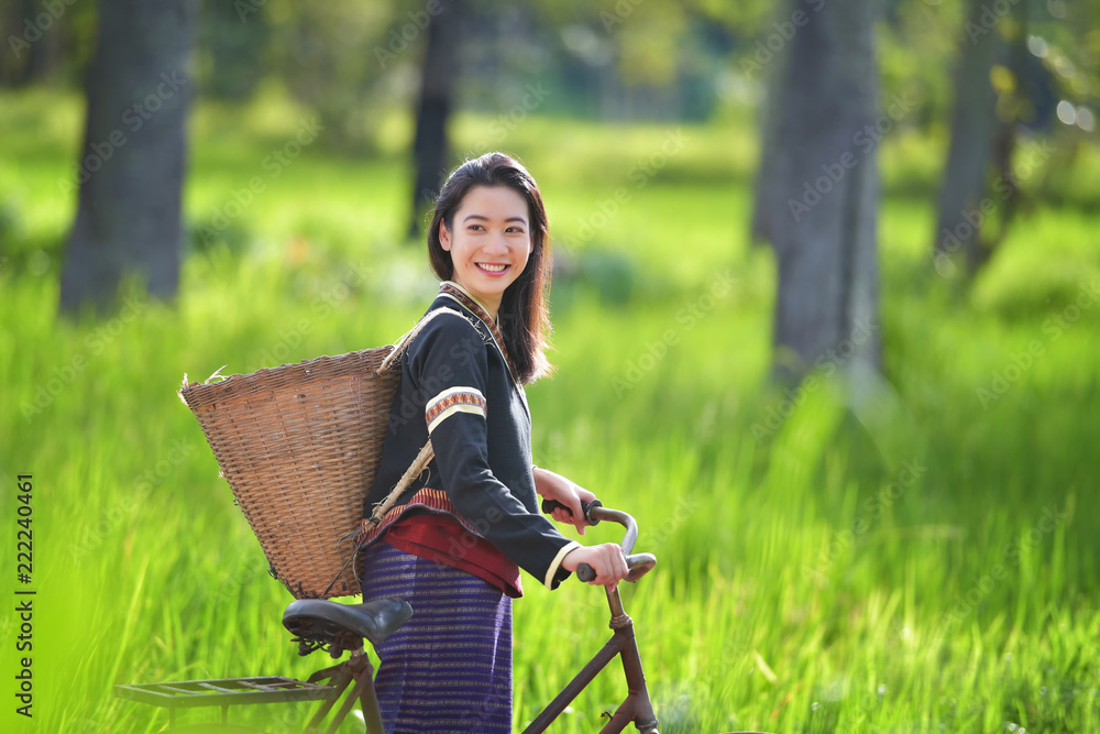 Traditional Hmong girl with basket of agricultural crops walking with ...