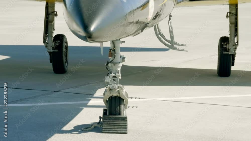 Medium shot of landing gear of military fighter located at the airport ...