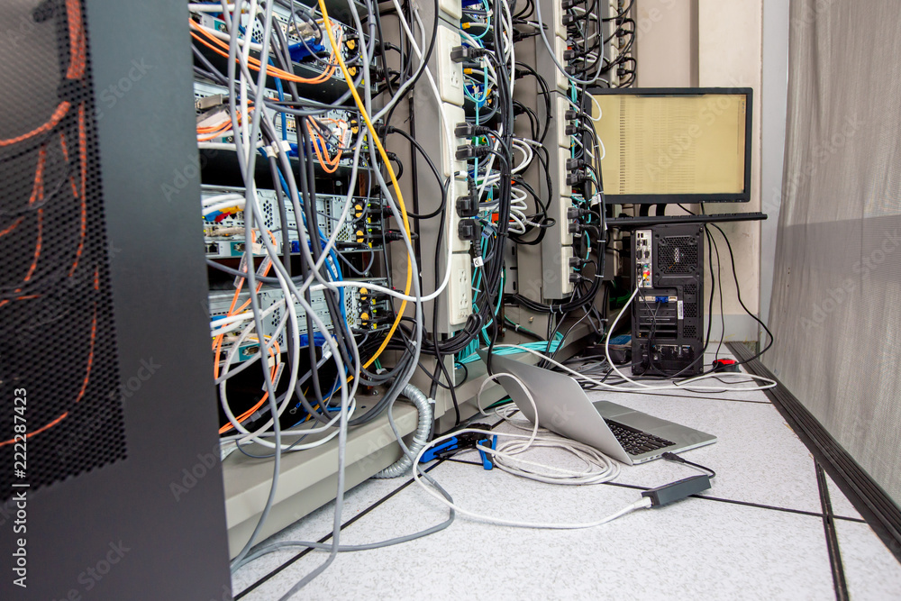Data center with laptop connecting for setup. Stock Photo | Adobe Stock