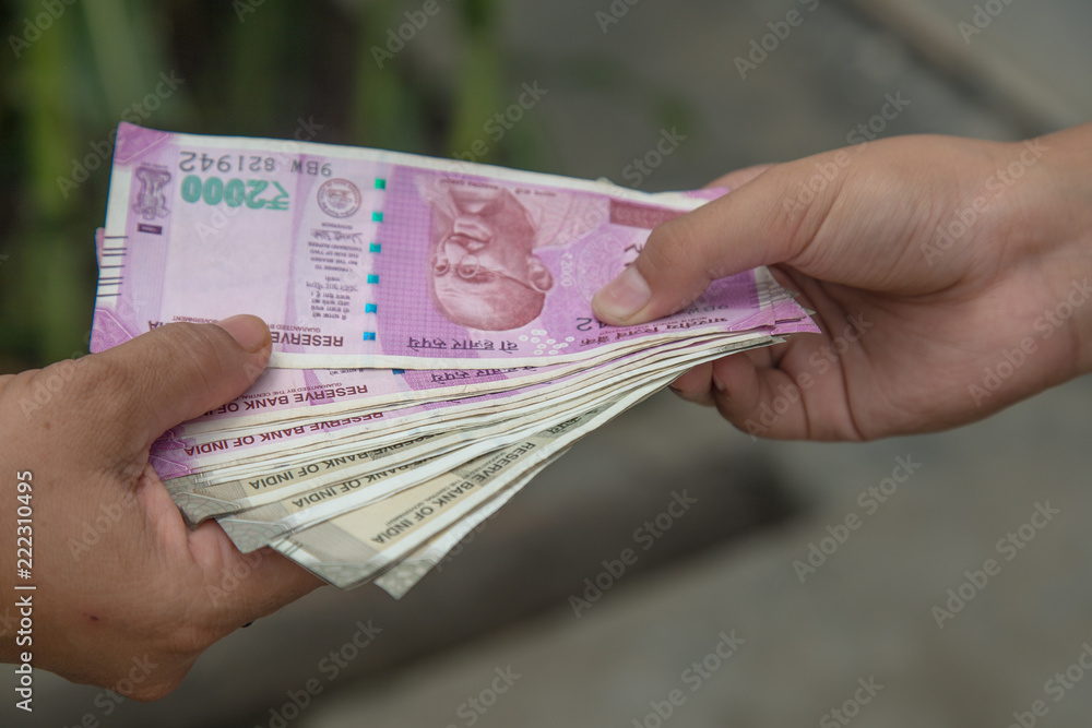 Indian rupees. Holding and giving Indian rupees to someone Stock Photo ...