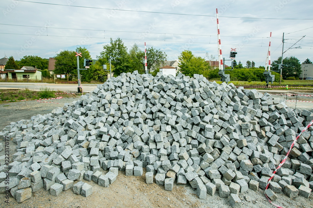 Big pile of grey paving blocks, square stones, reconstruction work on ...