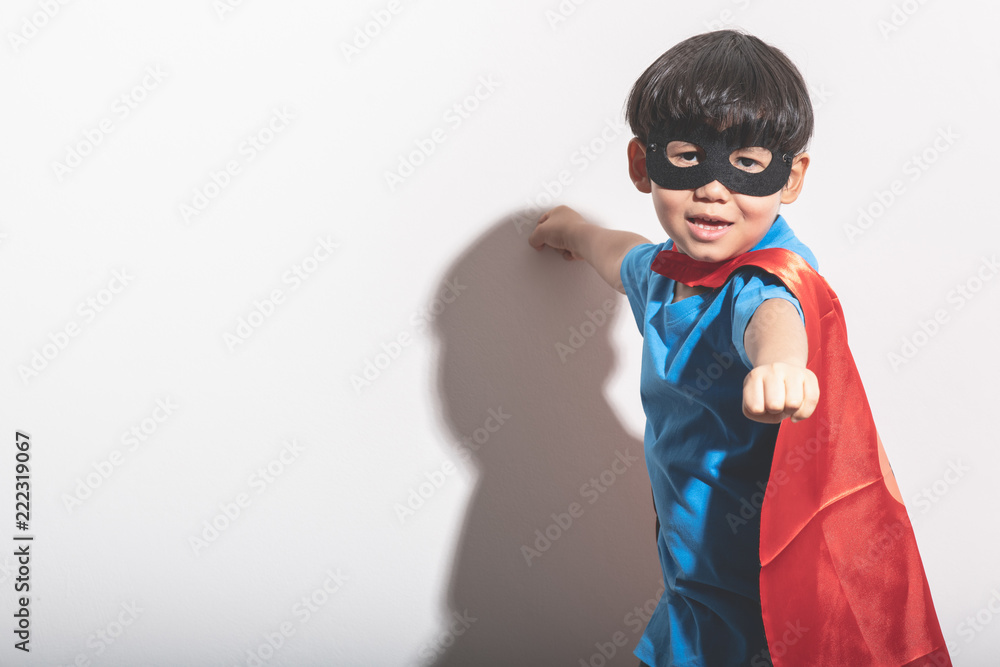Young boy super hero portrait in white background with hard light ...