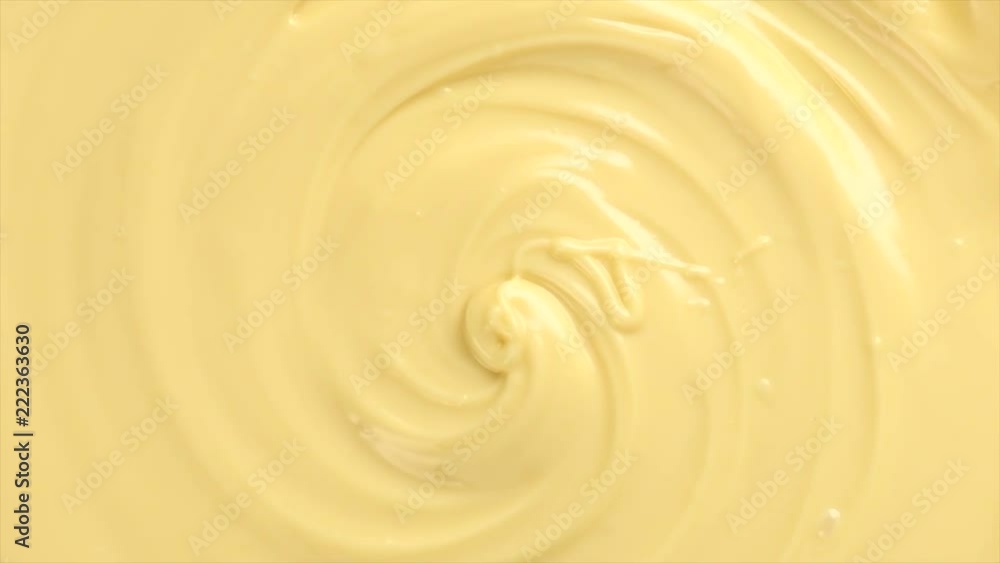 White molten chocolate swirl rotated background. Melted chocolate ...