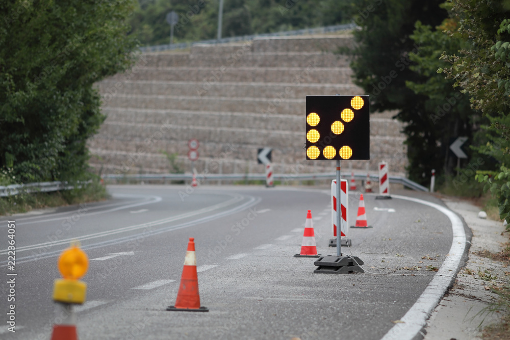 Roadworks, arrow traffic light and road signs at a road in Greece from ...