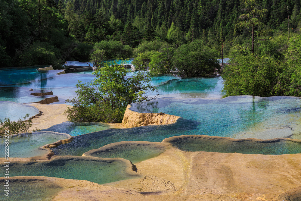 Blue colorful pools of clear water in Huanglong Scenic Area in Sichuan ...