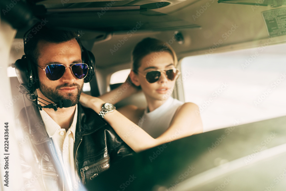 handsome male pilot in headset and sunglasses sitting with girlfriend ...