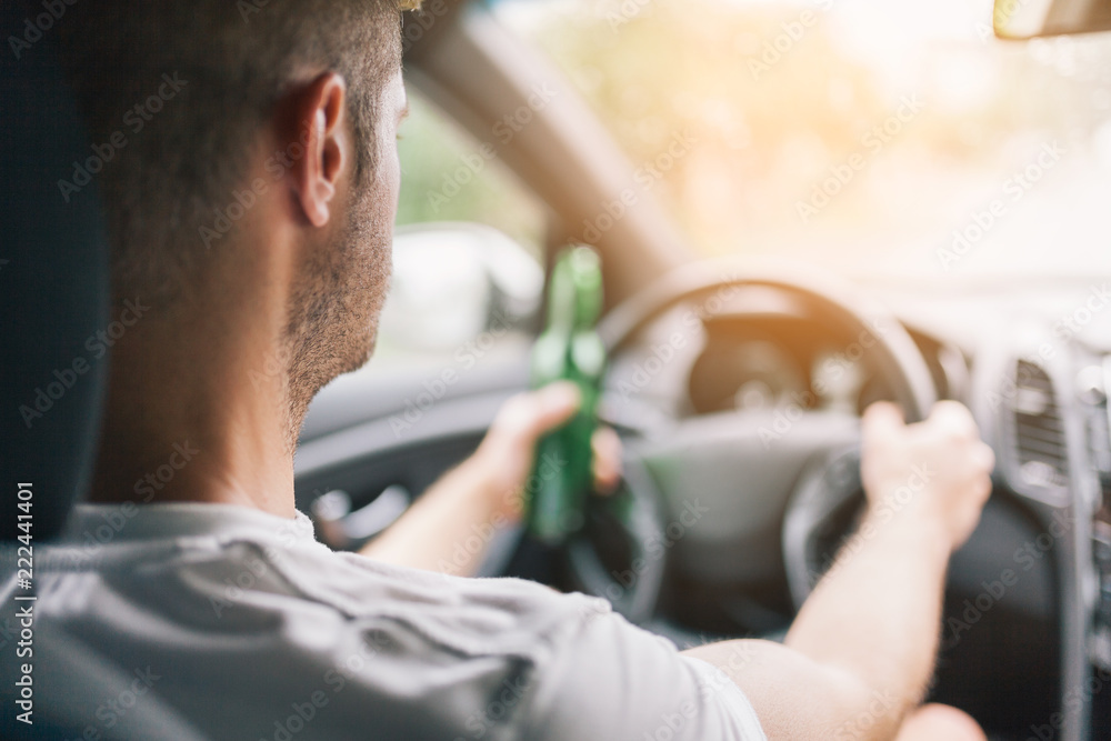 Drunk driver behind the steering wheel of a car Stock Photo | Adobe Stock