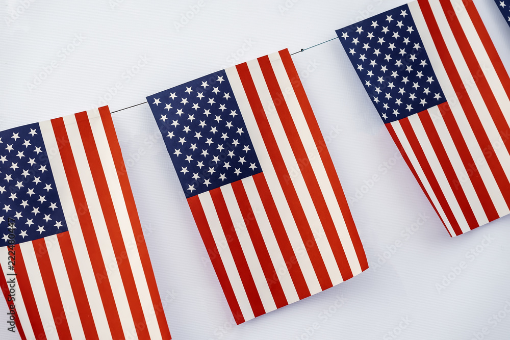 Garland of american flags of rectangular shape close-up on light ...